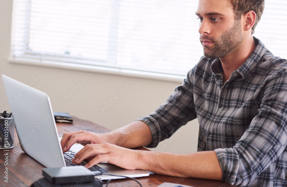 Young adult man looking frustrated and fed-up with work, while still ...