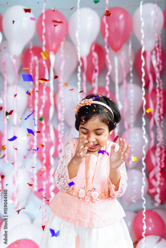 Cute little girl celebrating with confetti at her birthday party Stock ...