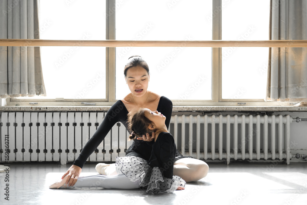 Female ballet instructor teaching girl in ballet studio Stock Photo ...