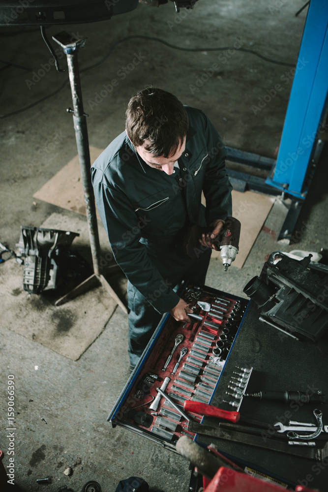 Mechanic working on car Stock Photo | Adobe Stock
