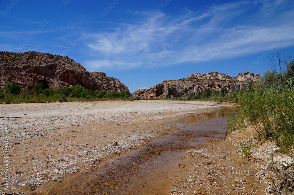 Rising global warming: wide river dried out to a tiny stream riverbed ...