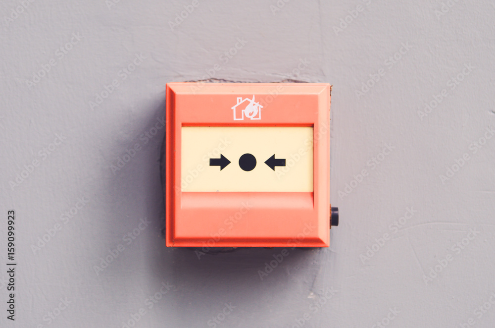 wall mounted Red fire alarm button used to activate warning systems in ...