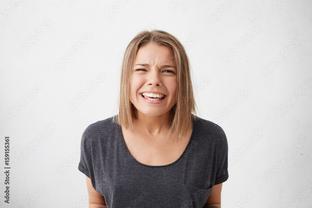 Pretty woman with bob hairstyle having positive expression grinning ...