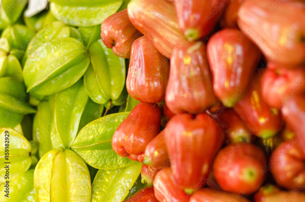 green starfruit and bell fruits background display on fresh market ...