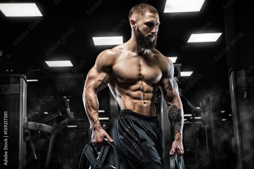 Attractive tall muscular bodybuilder doing heavy deadlifts in moder ...