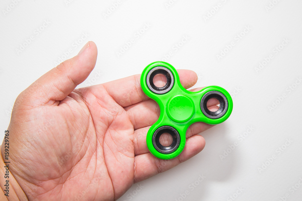 Green Fidget finger spinner toy image Stock Photo | Adobe Stock