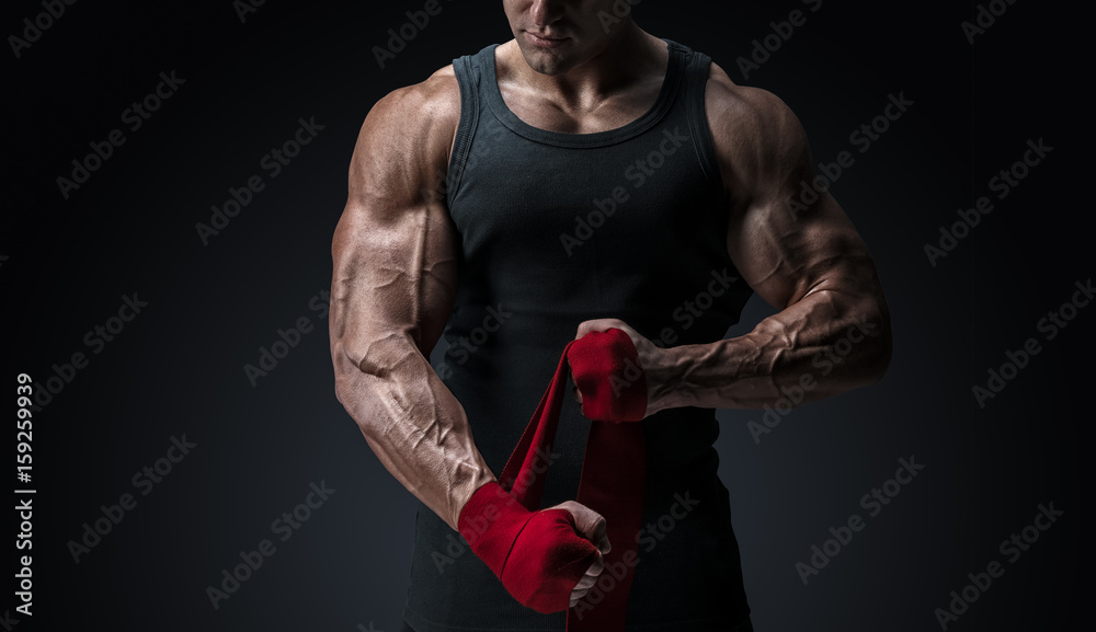 Strong man wrap hands on black background Man is wrapping hands with ...