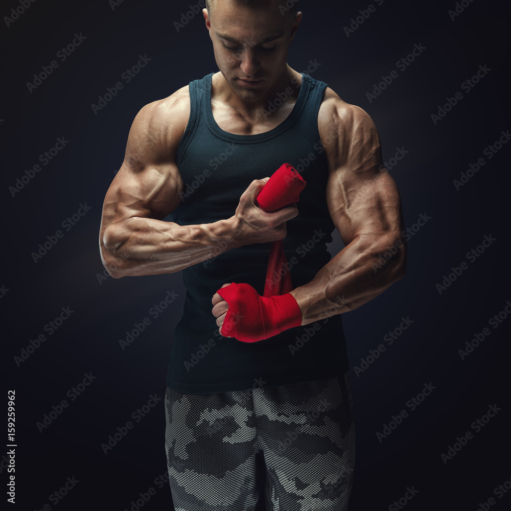 Strong man wrap hands on black background Man is wrapping hands with ...