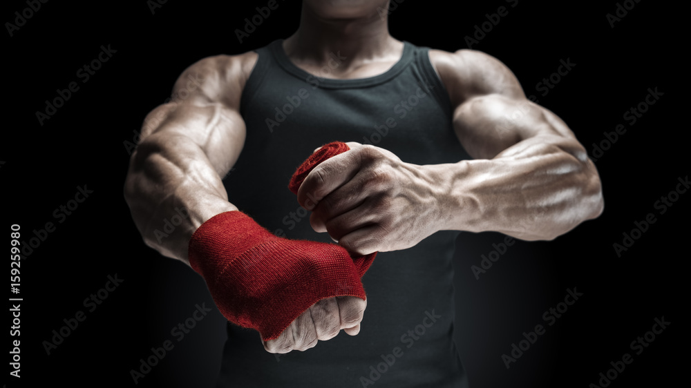 Close-up photo of strong man wrap hands on black background Man is ...