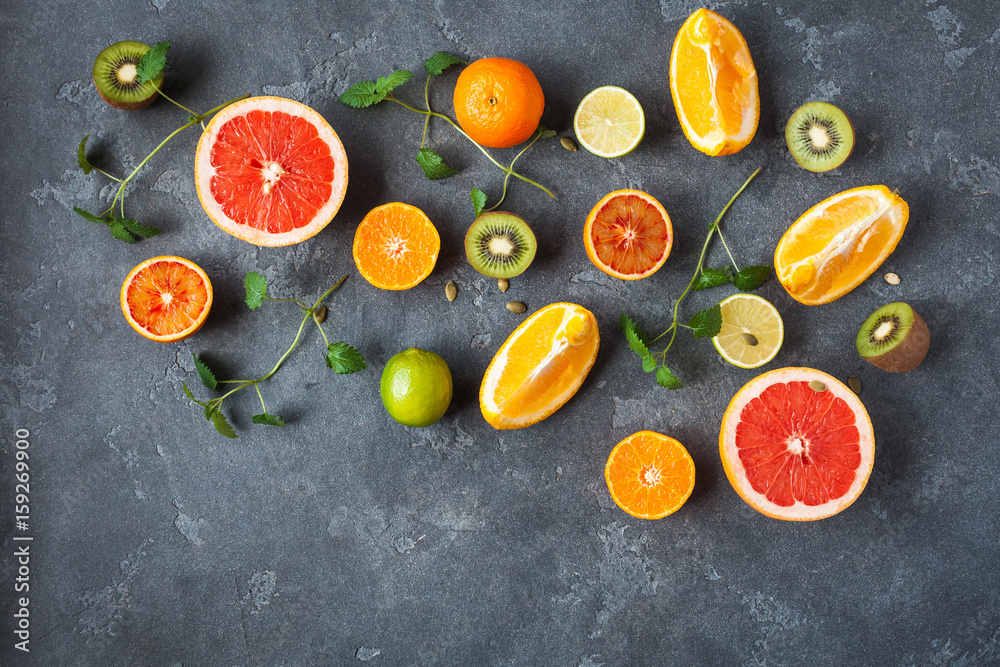 Fruit background. Colorful fresh fruit on dark table. Orange, tangerine ...