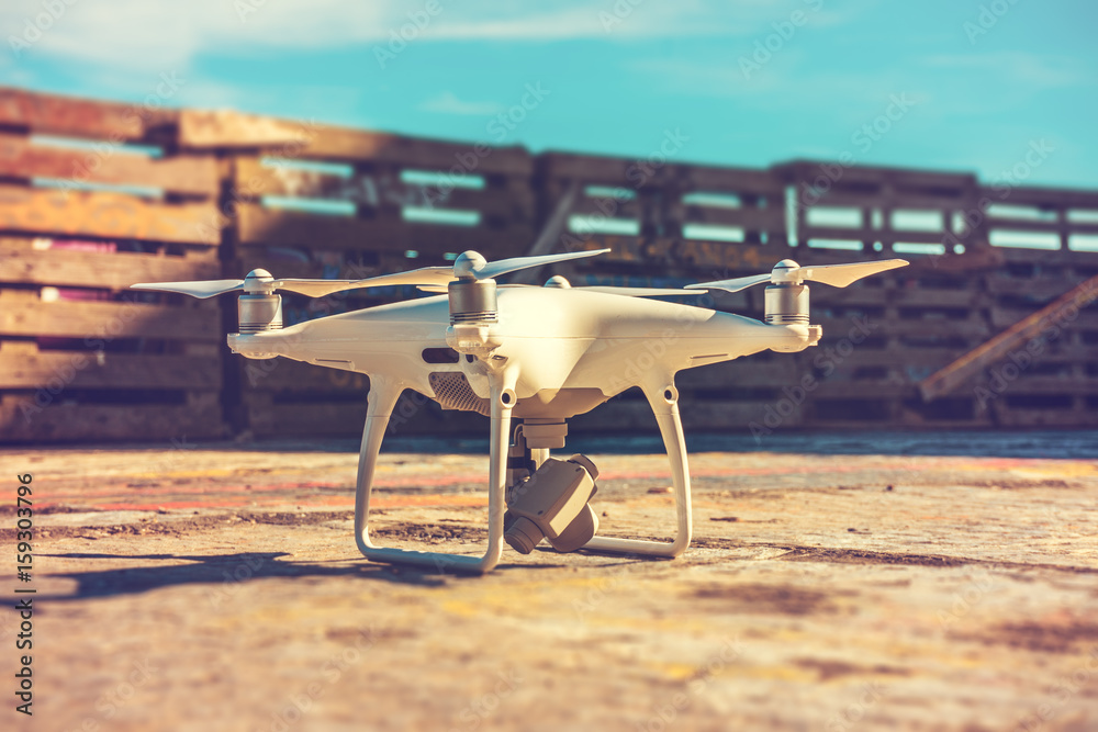 white drone is standing on the ground without logos and unsharpened ...