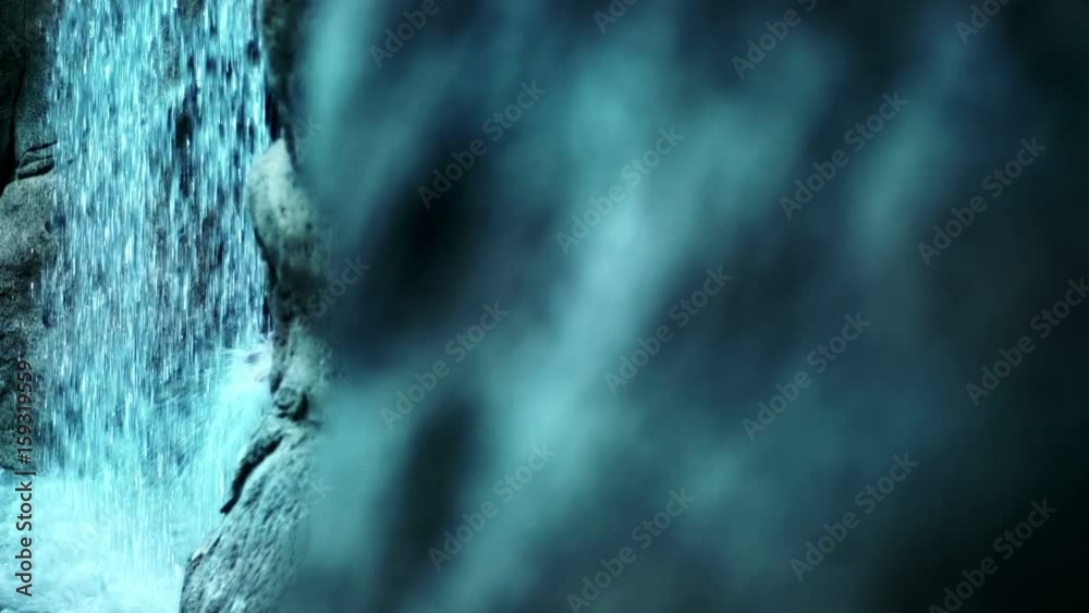 Water cascade flowing in slow motion. Waterfall on stony background ...