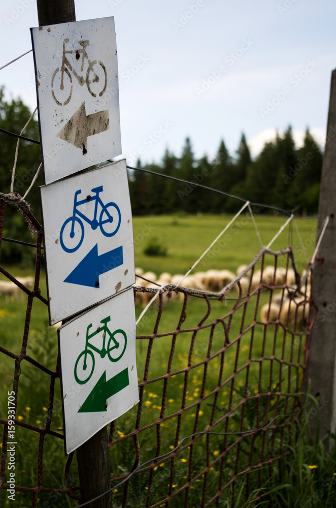 Signposts biking trails with arrow driving direction of the road in ...