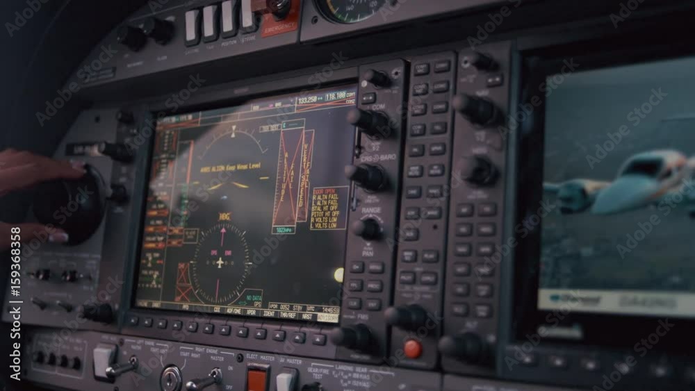 Navigation panel in airplane cockpit. Close up of female hand tuning ...
