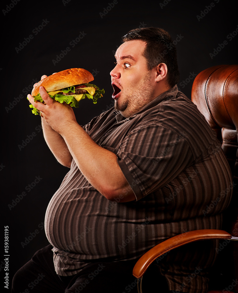 Diet failure of fat man eating fast food hamberger. Happy overweight ...