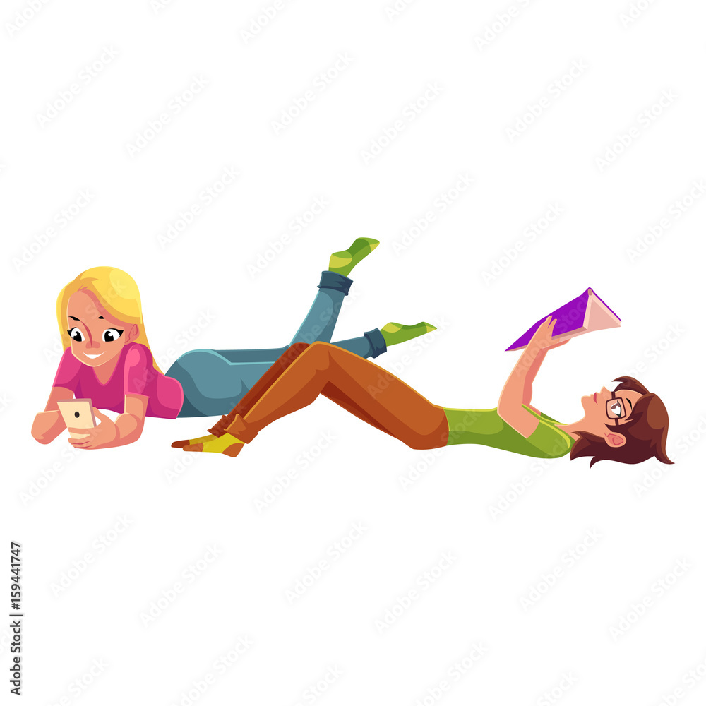 Two girls, one reading book, another playing with mobile phone, lying ...