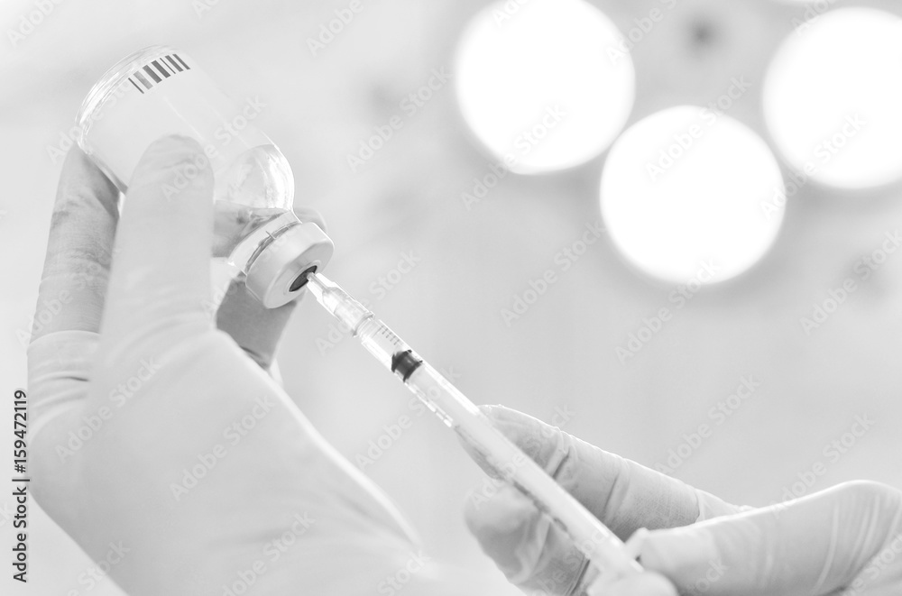 Hand holding syringe and medicine vial prepare for injection in ...