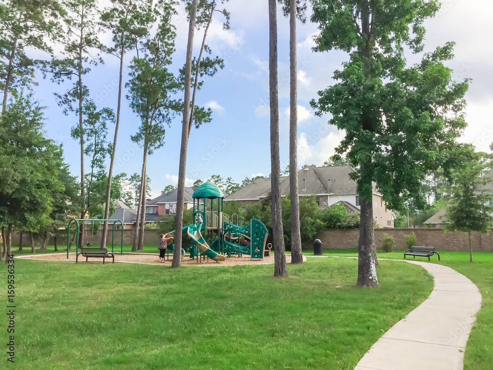 Children playground activities in residential area, pathway surrounded ...