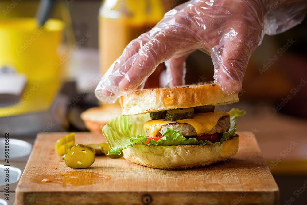 Making Delicious Homemade Maxi Burger with grilled beef steak, lettuce ...