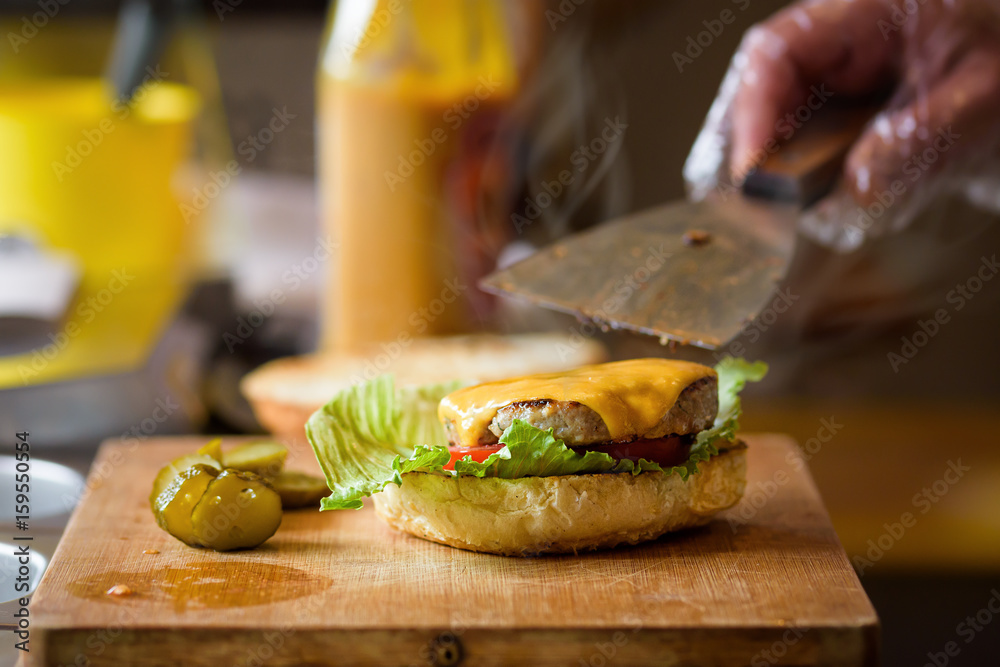 Making Delicious Homemade Maxi Burger with grilled beef steak, lettuce ...