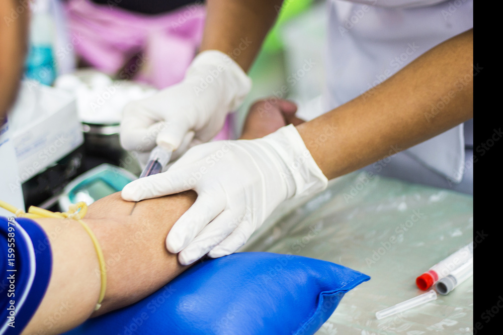 Physical examination - Nurse doing Blood sampling with syringe and ...