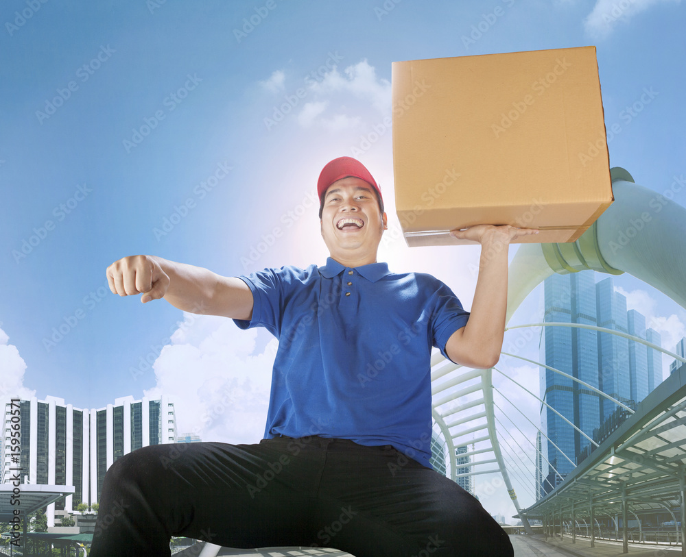 delivery man carrying card box with haapiness emotion in city building ...