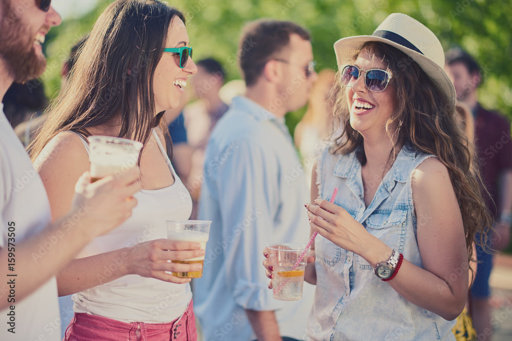 Group of people smiling, drinking, laughing and having a good time at ...