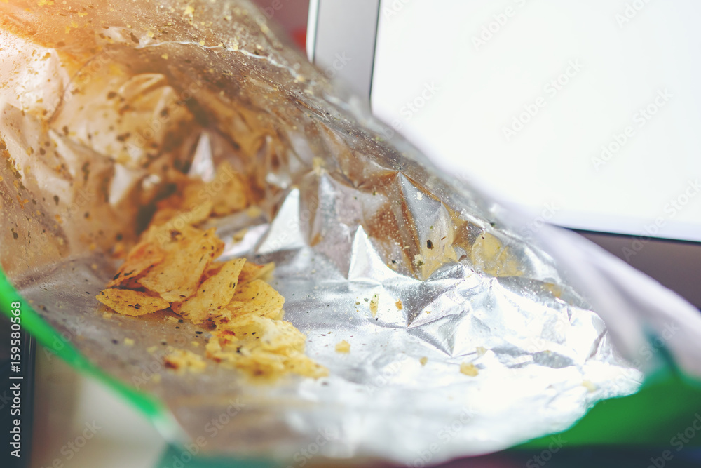 potato chips (empty) on notebook background Stock Photo | Adobe Stock