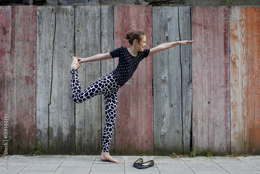 Teenage girl standing on one leg Stock Photo | Adobe Stock