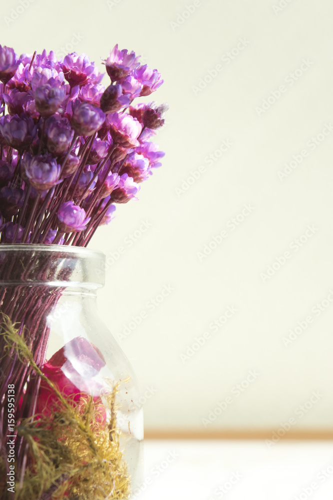 Small flowers in a bouquet inside a jar. Pink flowers with romantic ...