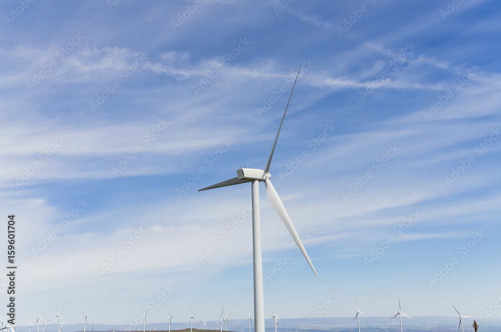 Low angle, close-up view a wind turbine tower again cloud blue sky on a ...
