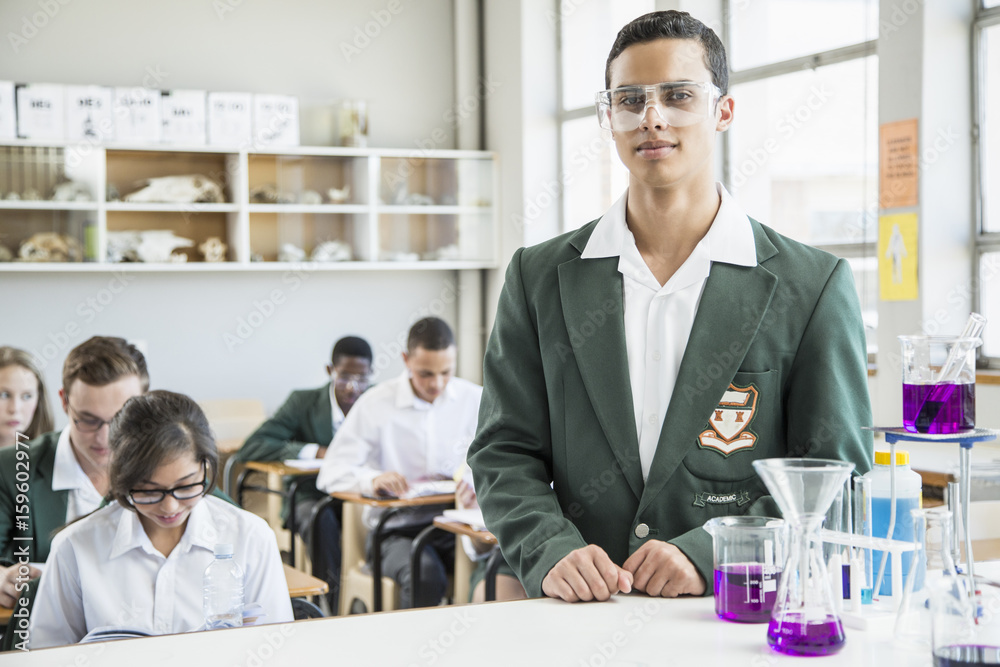 Student in lab, classmates in background Stock Photo | Adobe Stock