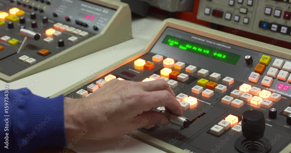 editor using a 1980s linear video production switch control panel and ...