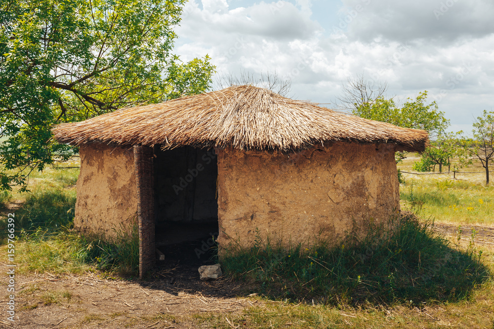 Old round house with thatched roof Stock Photo | Adobe Stock