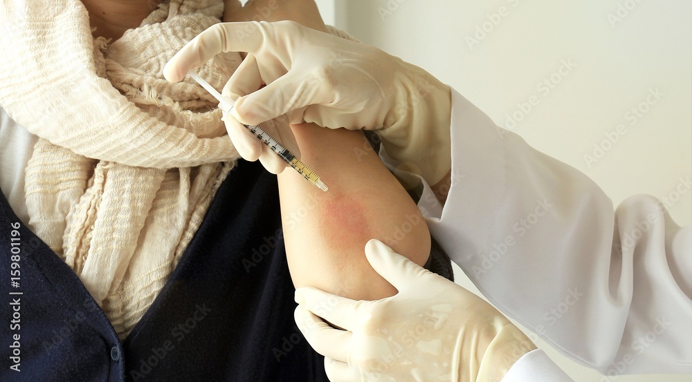 Doctor injecting at patient's arm, Dermatologist doctor doing treatment ...