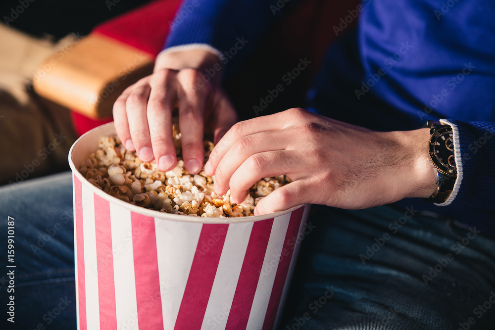 Male hand in a bucket of popcorn at the movie theater Stock Photo ...