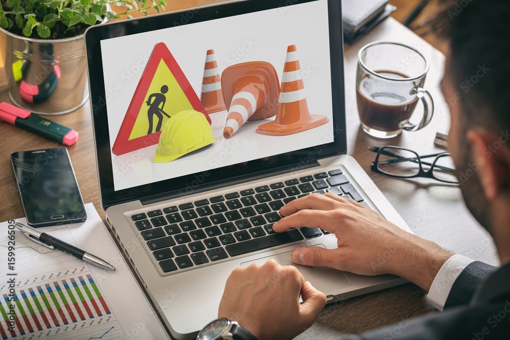 Under construction concept - laptop in an office background Stock Photo ...