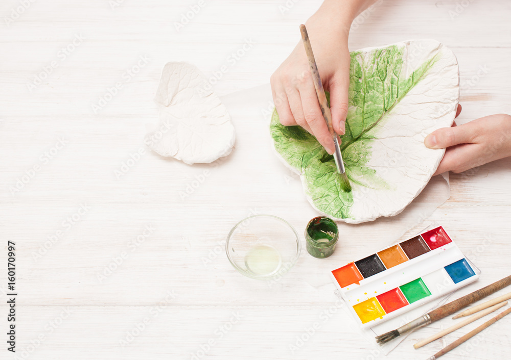 Coloring the plaster form of the sheet with hands Stock Photo | Adobe Stock