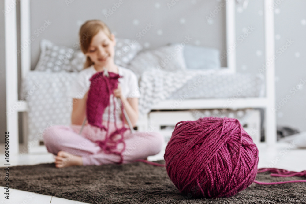Cute diligent little girl knitting something Stock Photo | Adobe Stock
