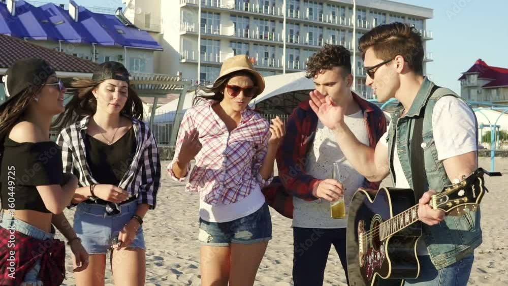 Summer party on the beach. Young boys and girls drinking cocktails ...