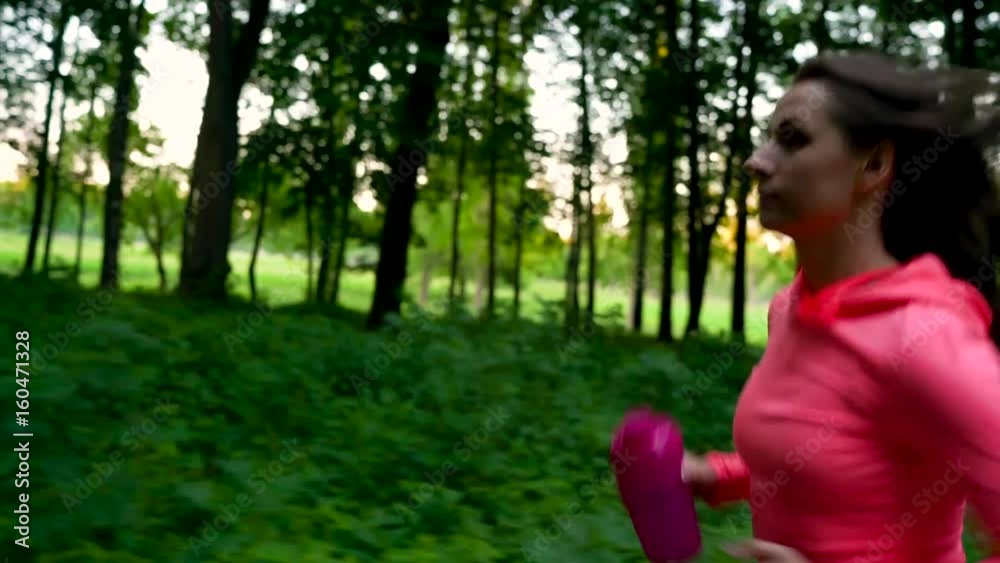 Woman runs through the forest Stock Video | Adobe Stock