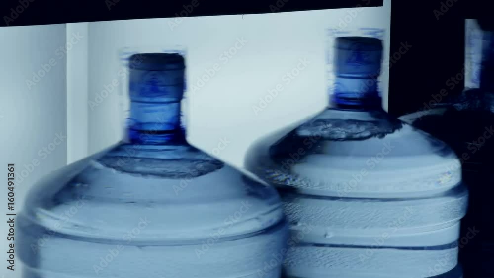 19 liter bottles filled with water moving on a conveyor. vídeo do Stock ...