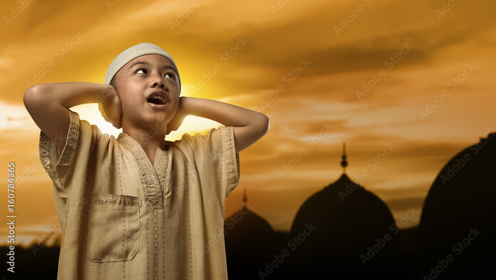 Little asian muslim boy with cap praying Stock Photo | Adobe Stock