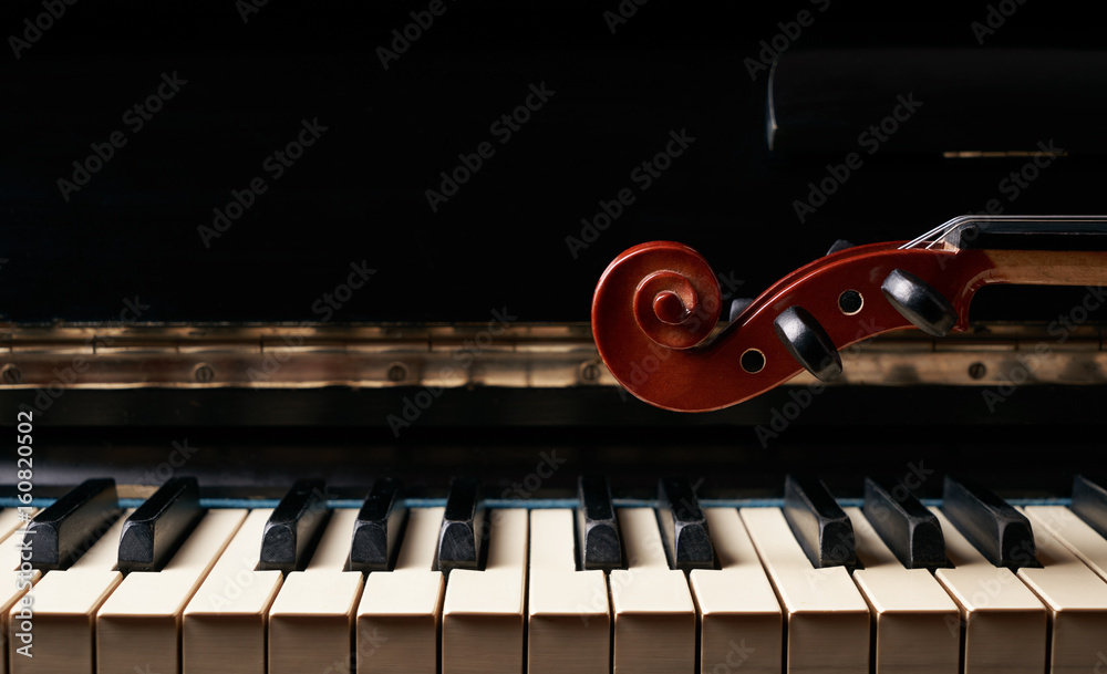 Classical musical stringed instrument violin on piano keys. Fiddle on ...