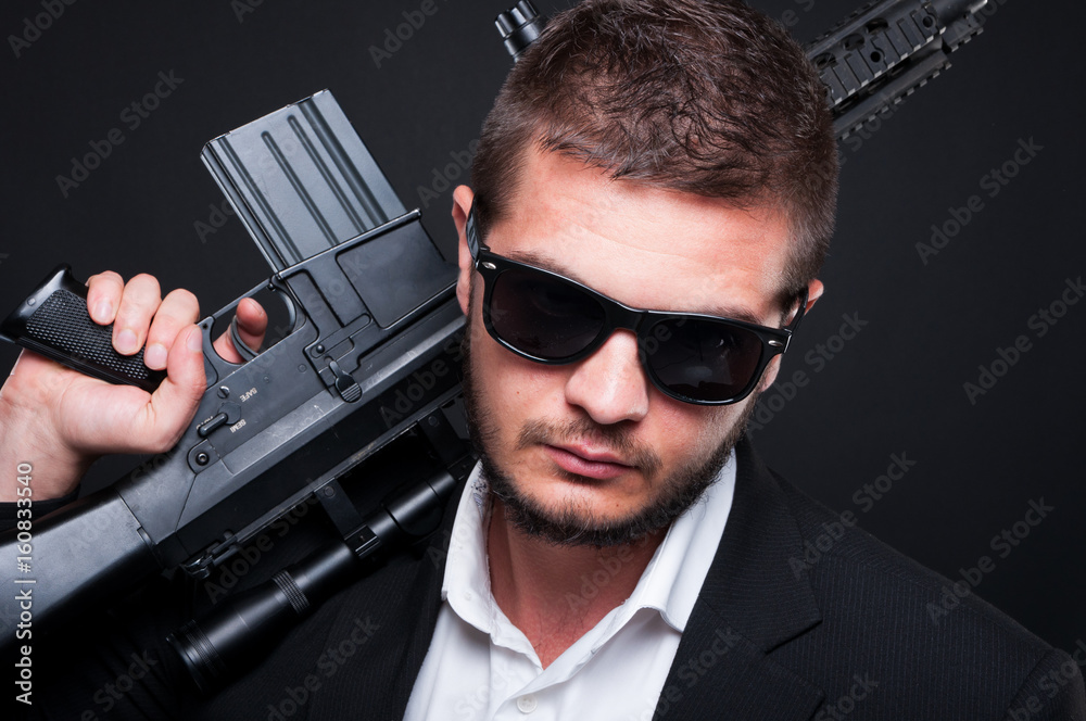 Closeup portrait of male gangster with automatic weapon Stock Photo ...