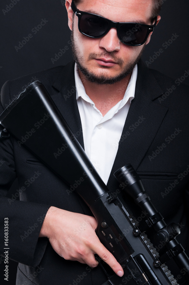 Portrait of man with machine gun in hands Stock Photo | Adobe Stock