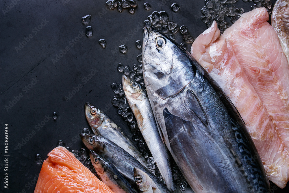 Variety of raw fresh fish. Whole tuna and herring, fillet of salmon ...