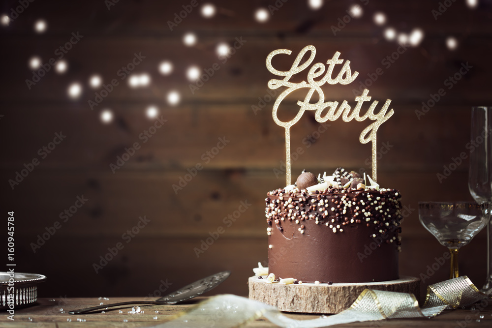 Chocolate birthday cake at a party Stock Photo | Adobe Stock