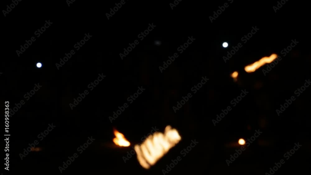 Blurred View, Fire Show. Men fight fiery swords. Blurry background ...