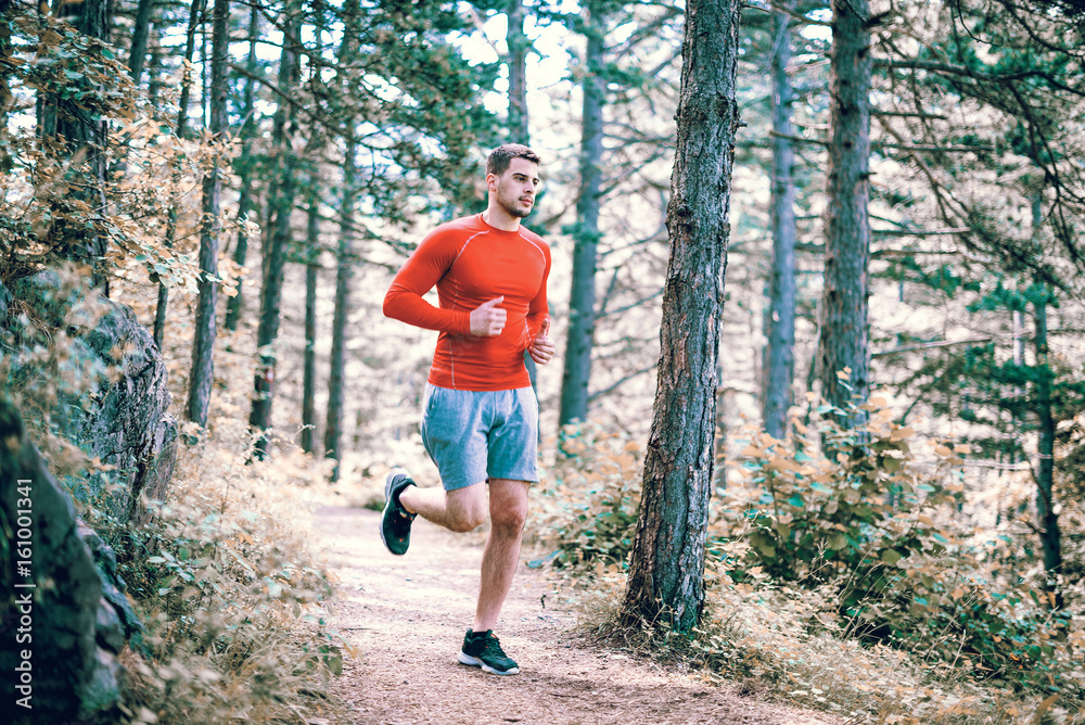 Man running through the forest. Stock Photo | Adobe Stock